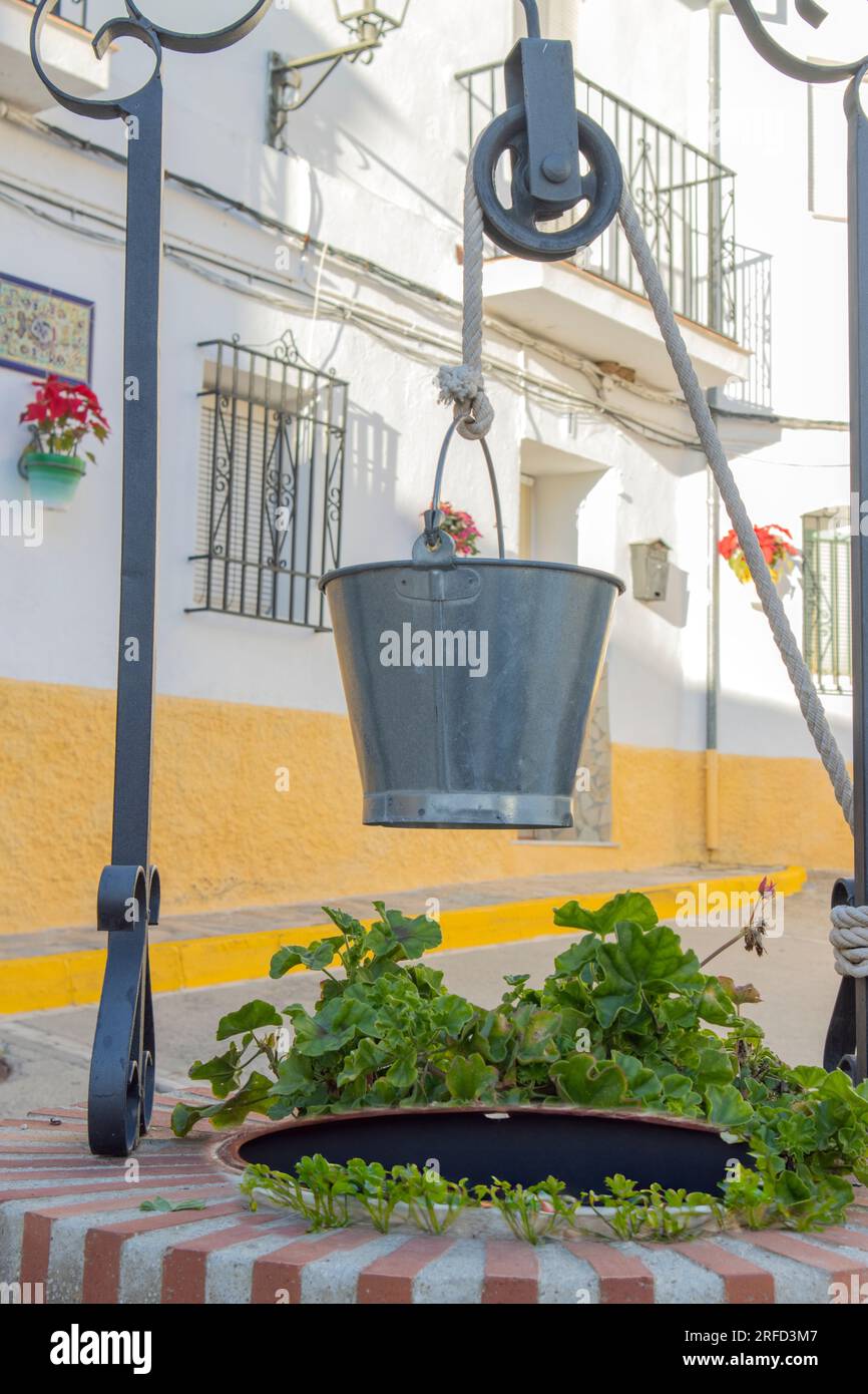 photography of well with bucket in town street Stock Photo - Alamy