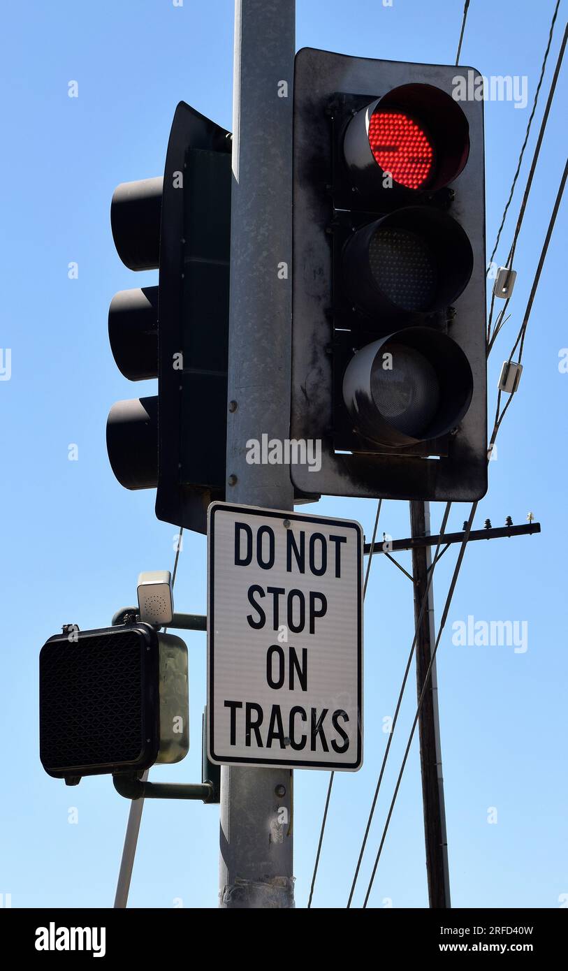 red traffic signal light and Do Not Stop on Tracks sign in California ...
