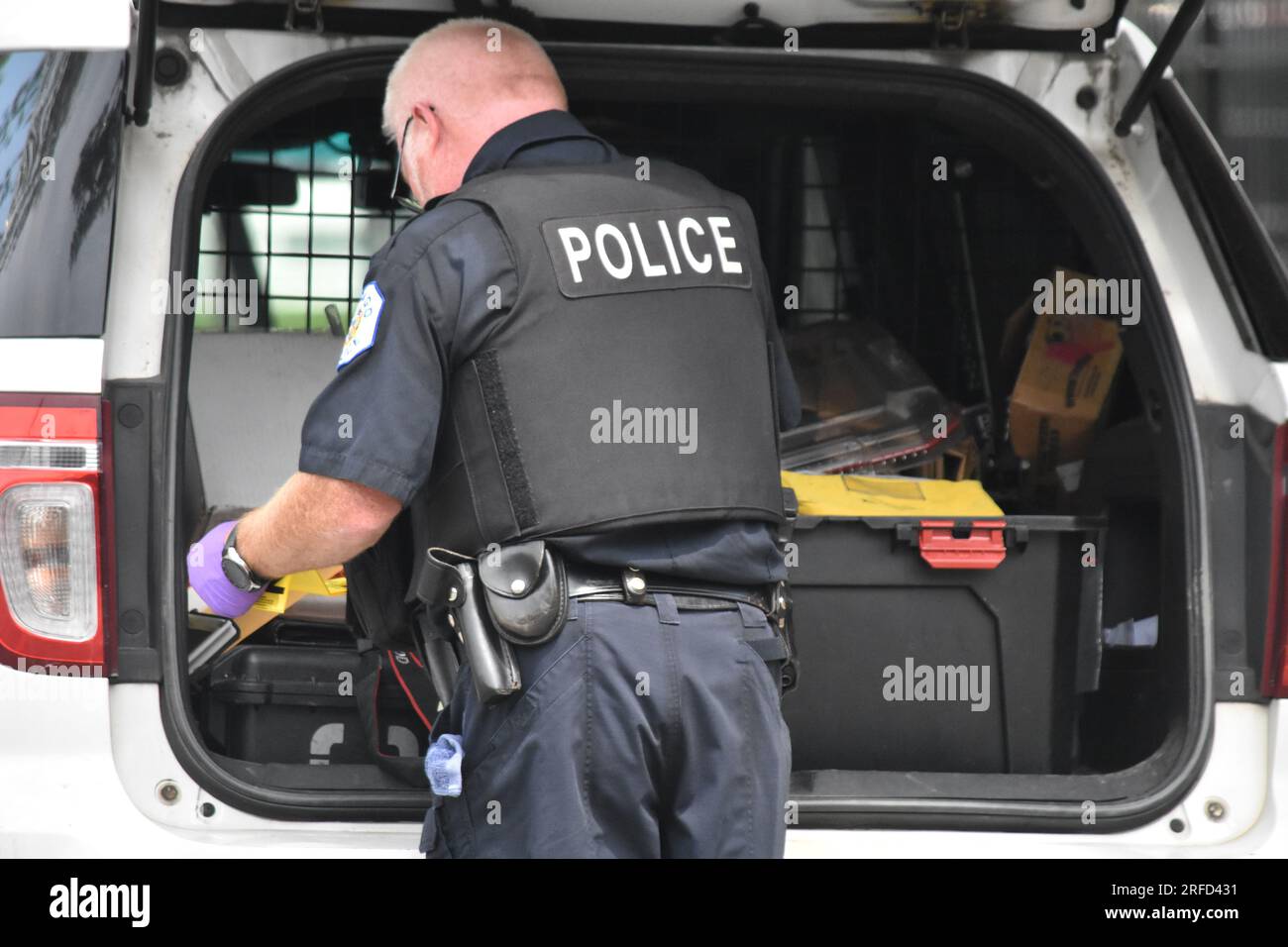 Chicago, United States. 02nd Aug, 2023. Police officer sorts through ...
