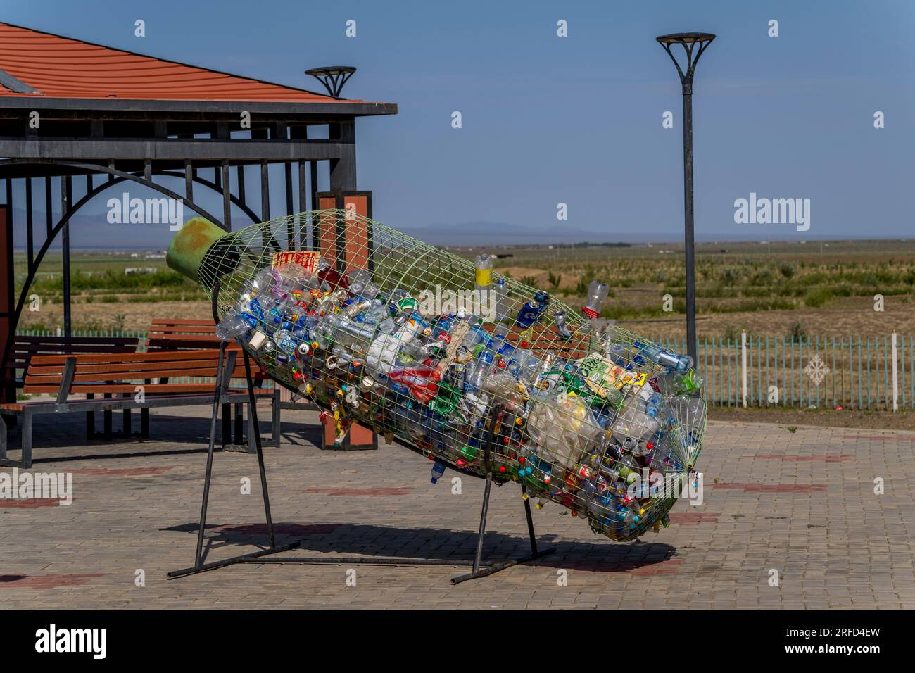 A plastic recycling station in form of a bottle at the welcoming gate ...
