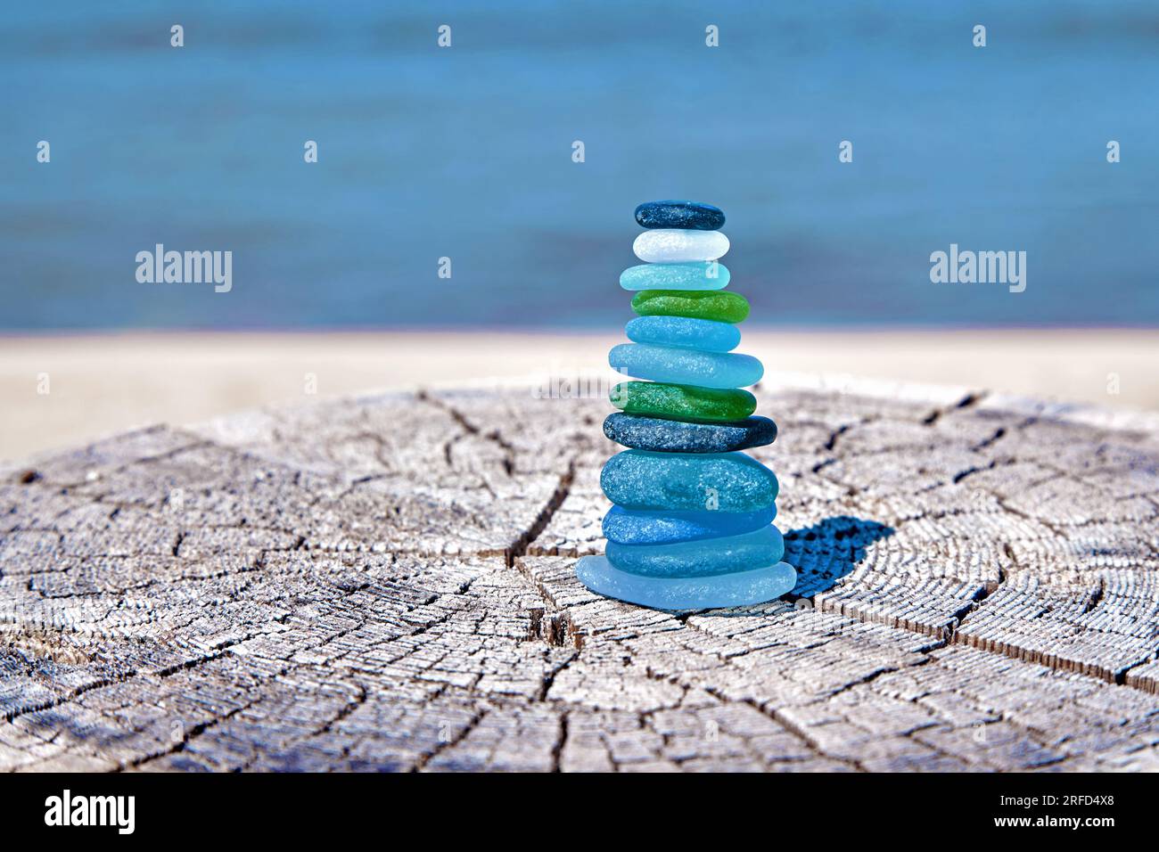 Balanced pyramid of glass bottle shards polished by sea On wooden ...