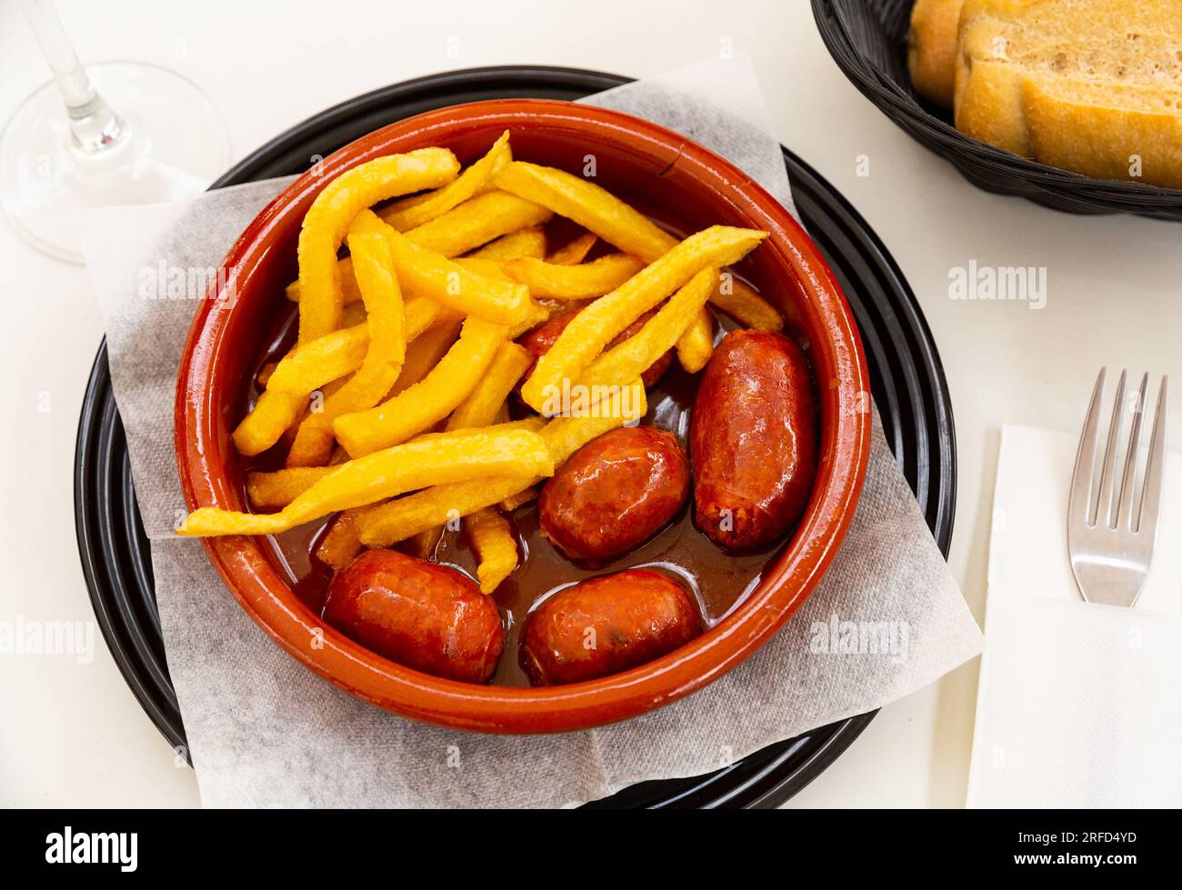 Popular Spanish tapa of smoked chorizo cooked in cider Stock Photo - Alamy