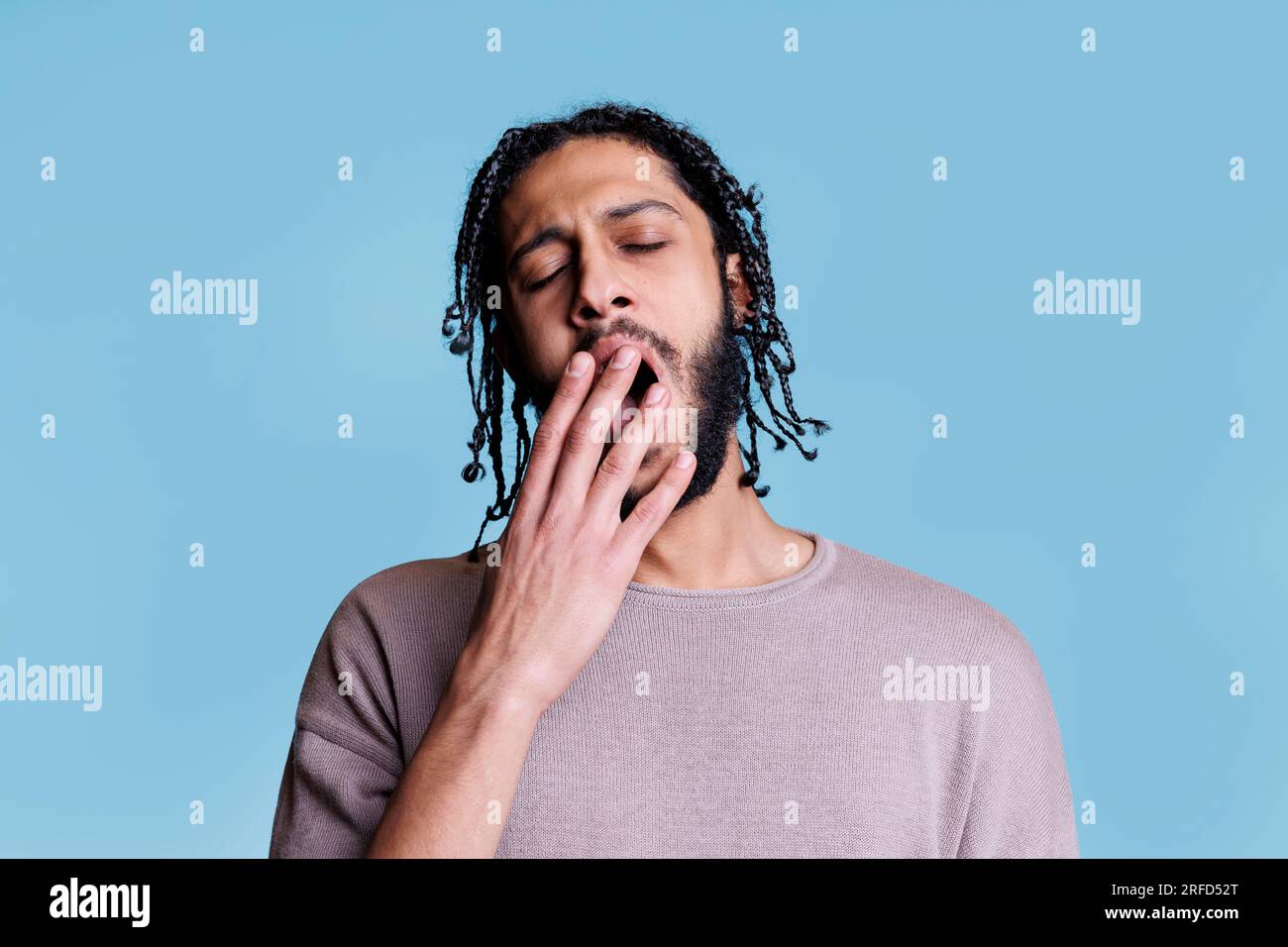 Tired arab man yawning while covering mouth with hand. Exhausted sleepy ...