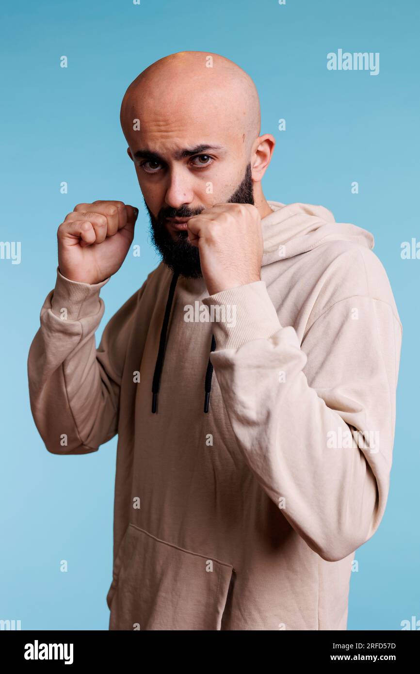 Arab man in boxing position looking at camera, ready to fight. Serious ...