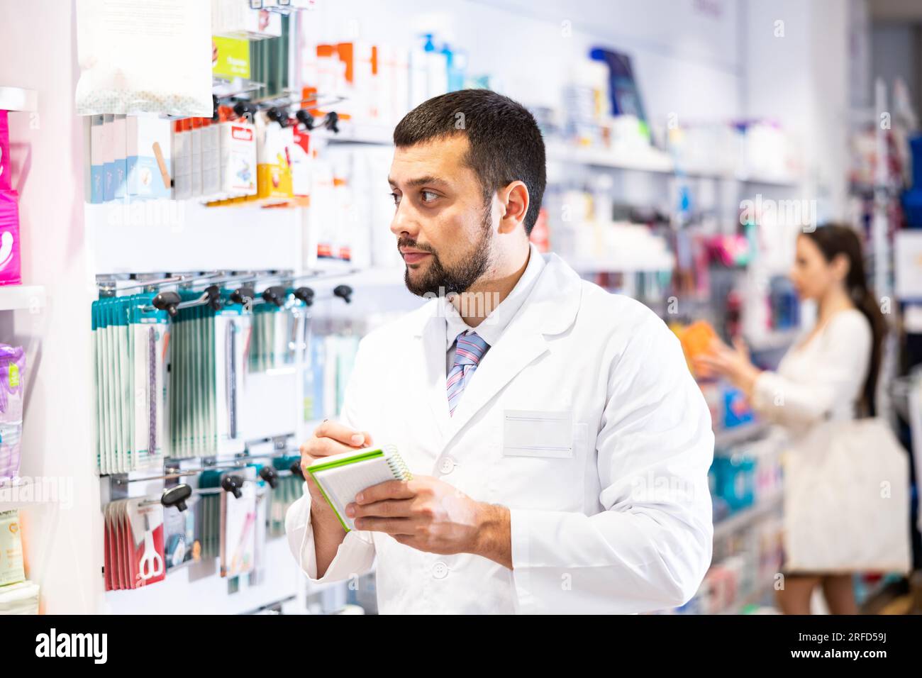 Male pharmacist checking assortment of drugs Stock Photo - Alamy