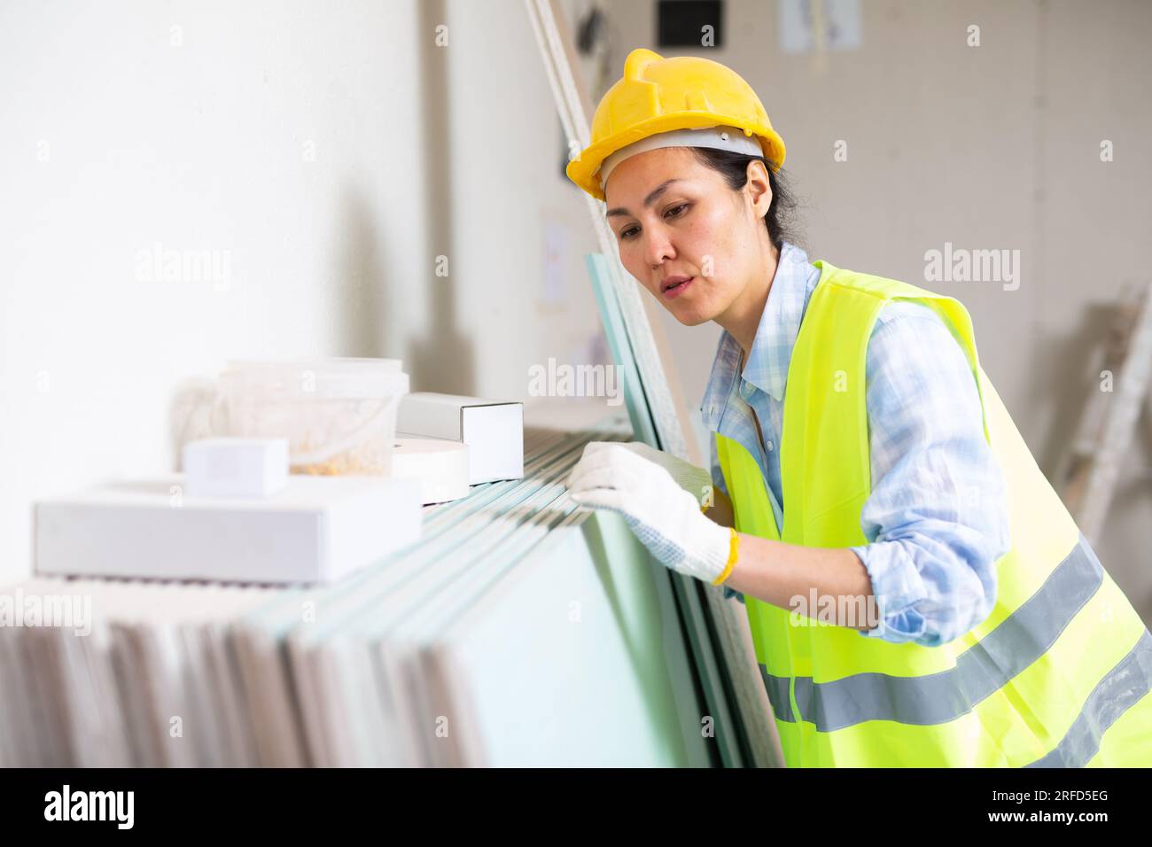Focused woman builder, checks the construction panels Stock Photo - Alamy