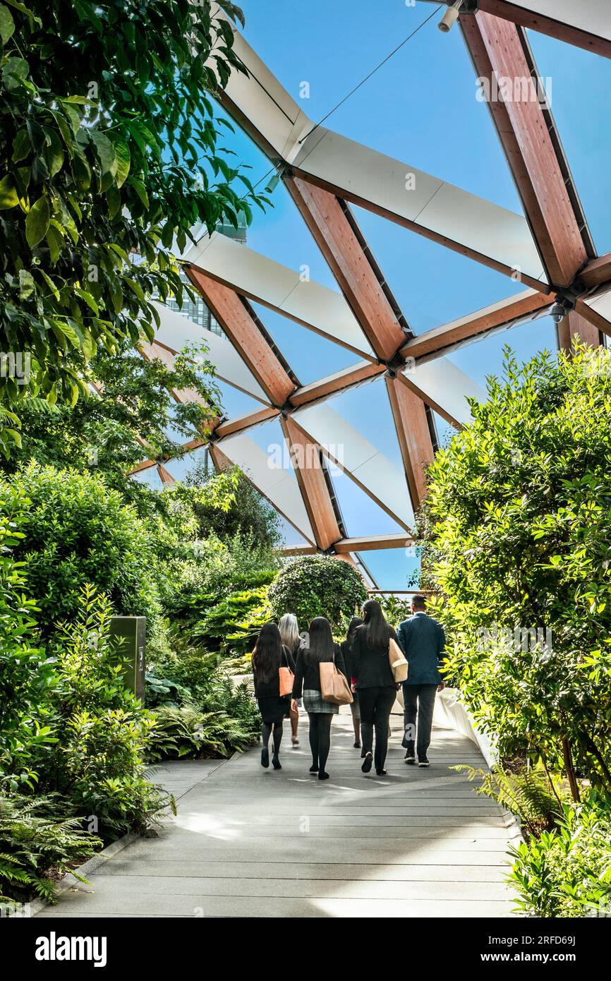 ROOF GARDEN Crossrail Place with office workers walking through at Canary Wharf. A tropical ...