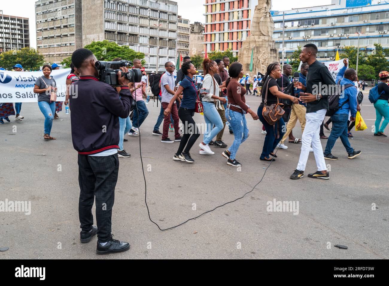 Maputo, Mozambique -- May 1, 2023. A film crew photographs a march in ...