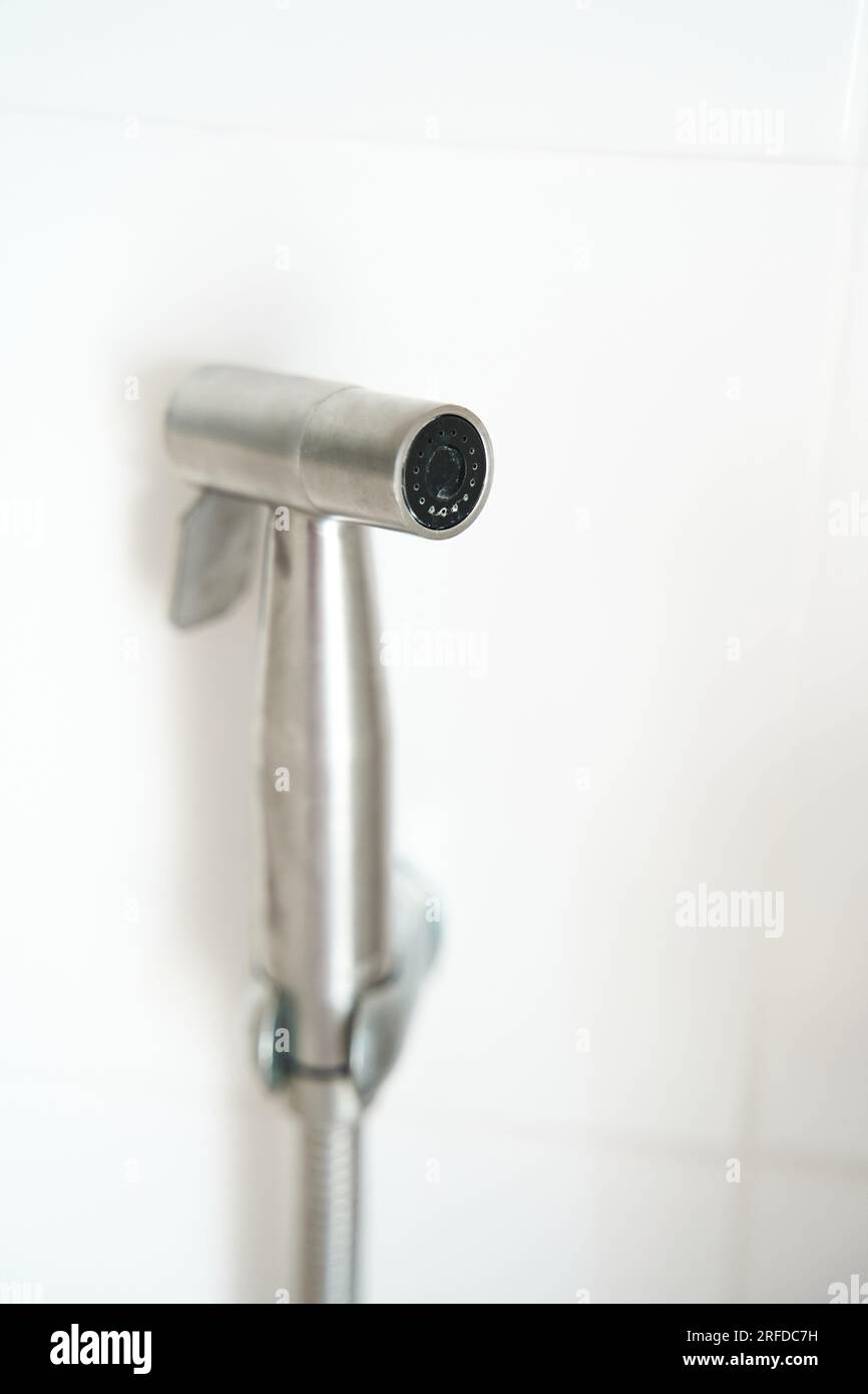 Hygiene concept. New hygienic stall shower head on the white wall ...