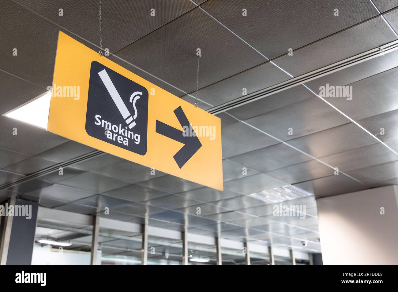 Direction signage to smoking area at airport terminal departure hall ...