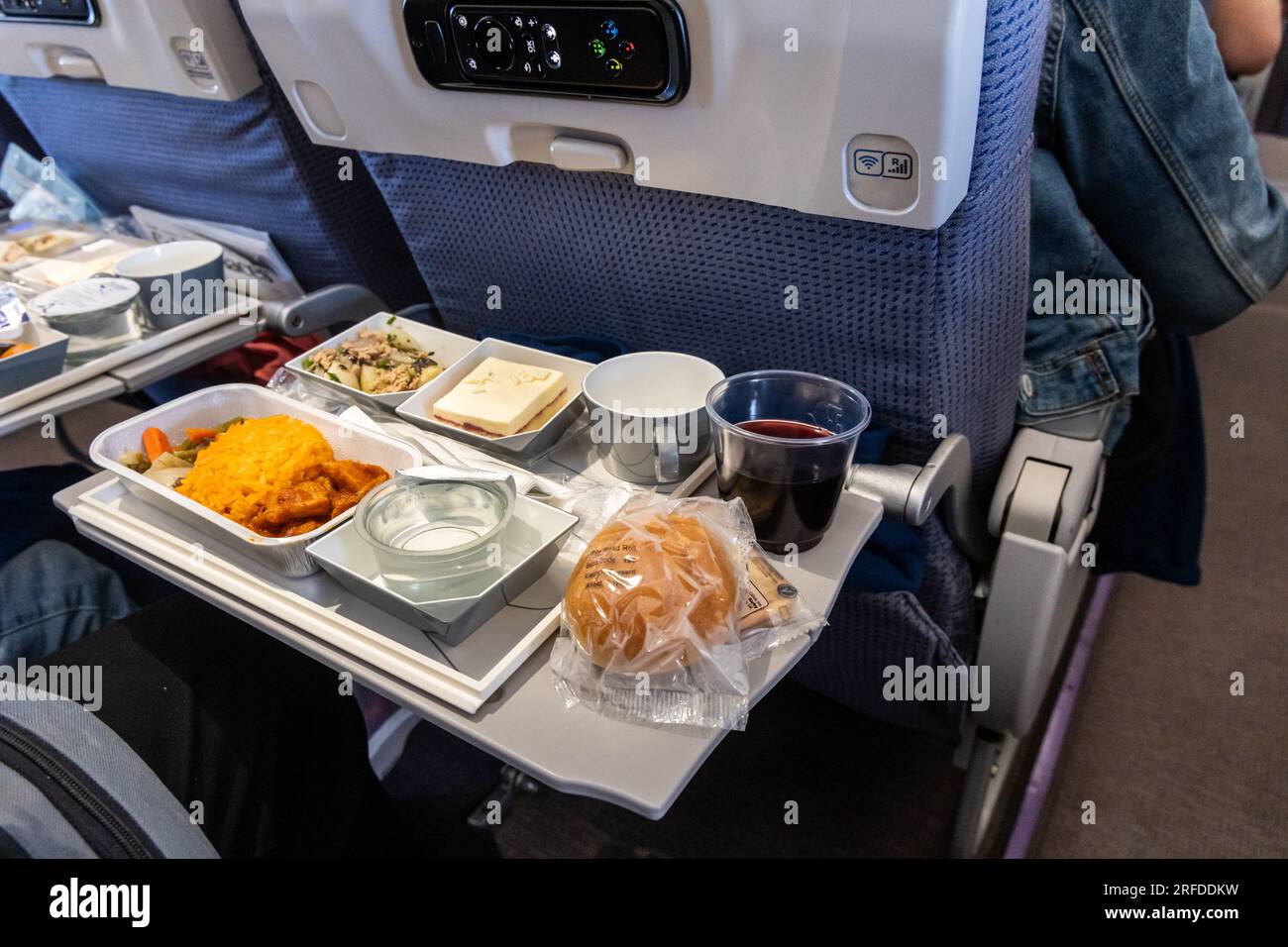 Inflight airplane Asian food set meal served consisting rice and spicy ...