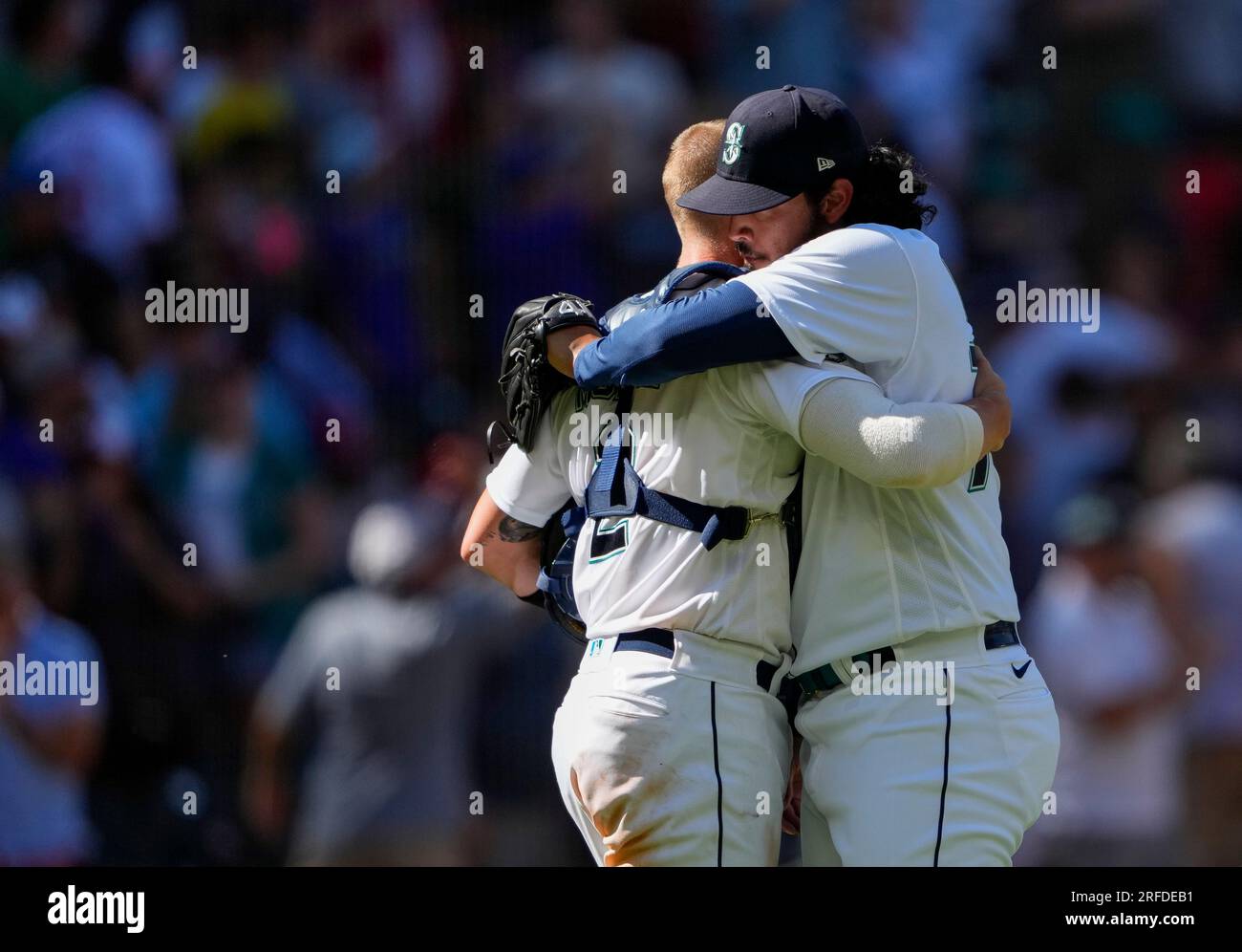 Seattle Mariners catcher Tom Murphy, left, hugs relief pitcher Andres Munoz after Munoz earned ...