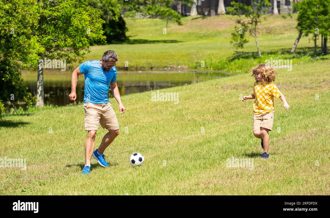 Active father son playing football in summer. Father and child son ...