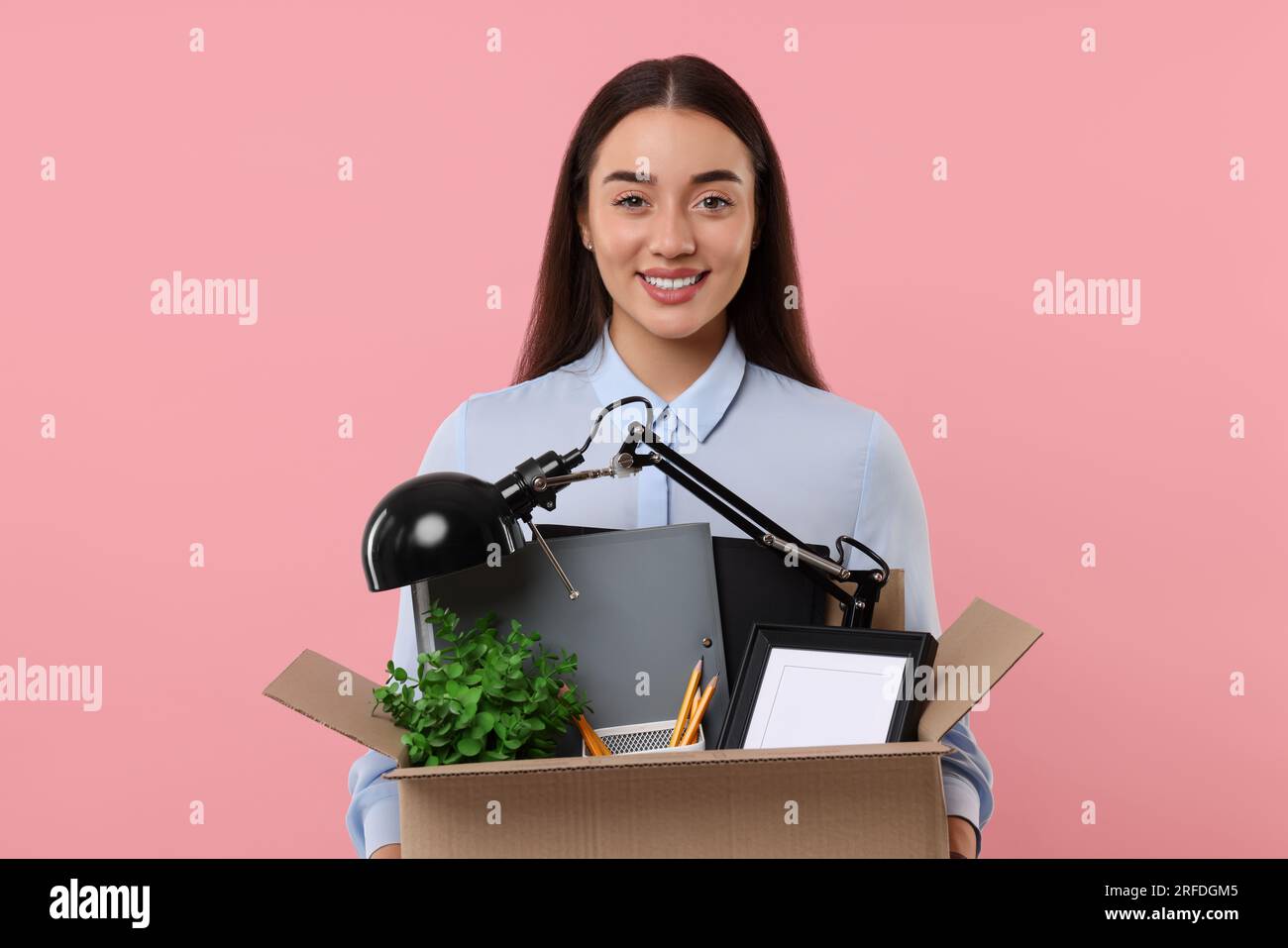 Happy unemployed woman holding box of personal office belongings on ...