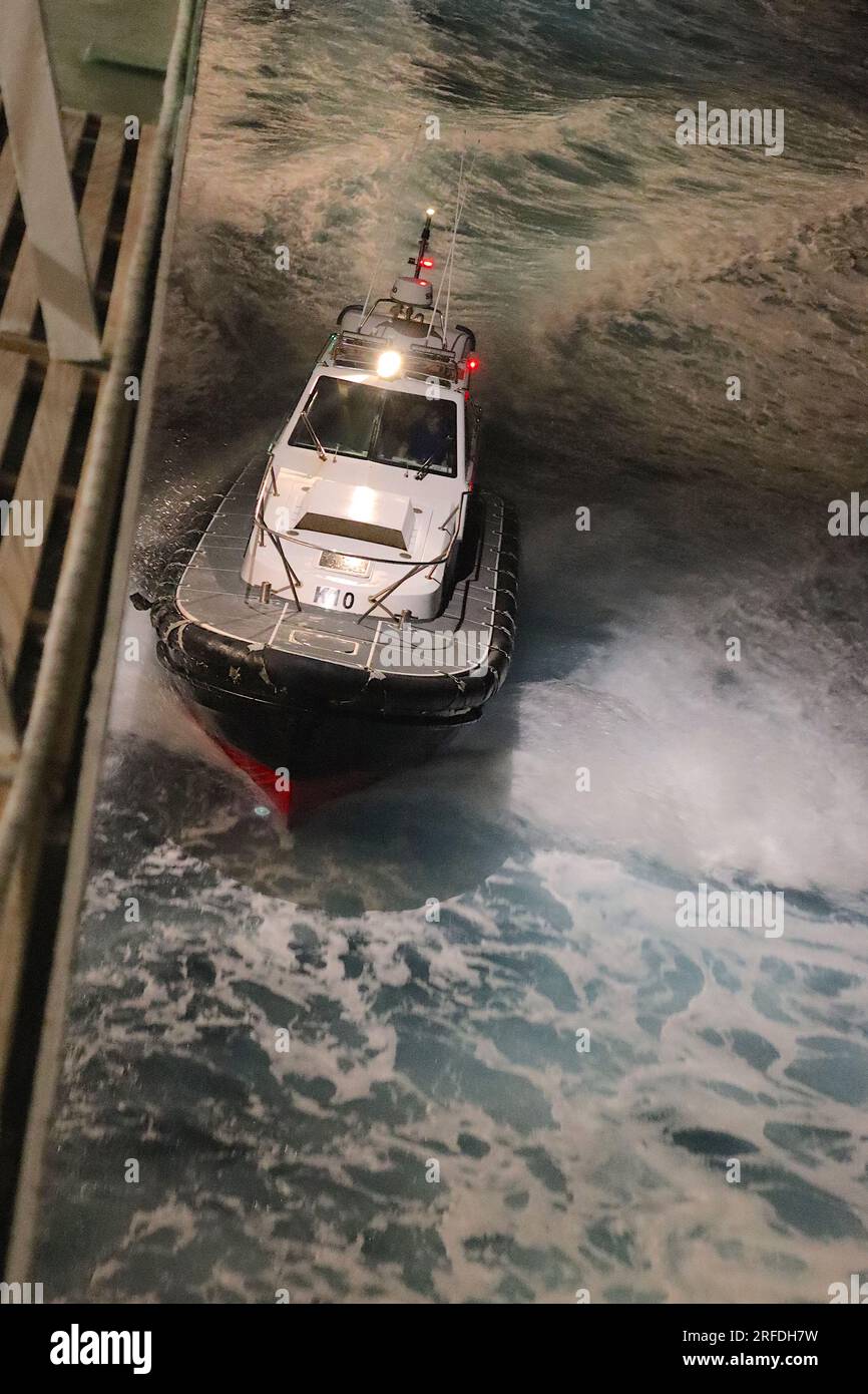 Strait of Messina, a pilot boat accelerates through Aurora’s bow wave ...
