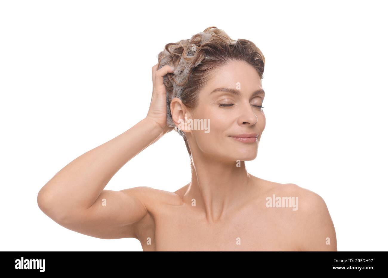 Beautiful woman washing hair on white background Stock Photo - Alamy