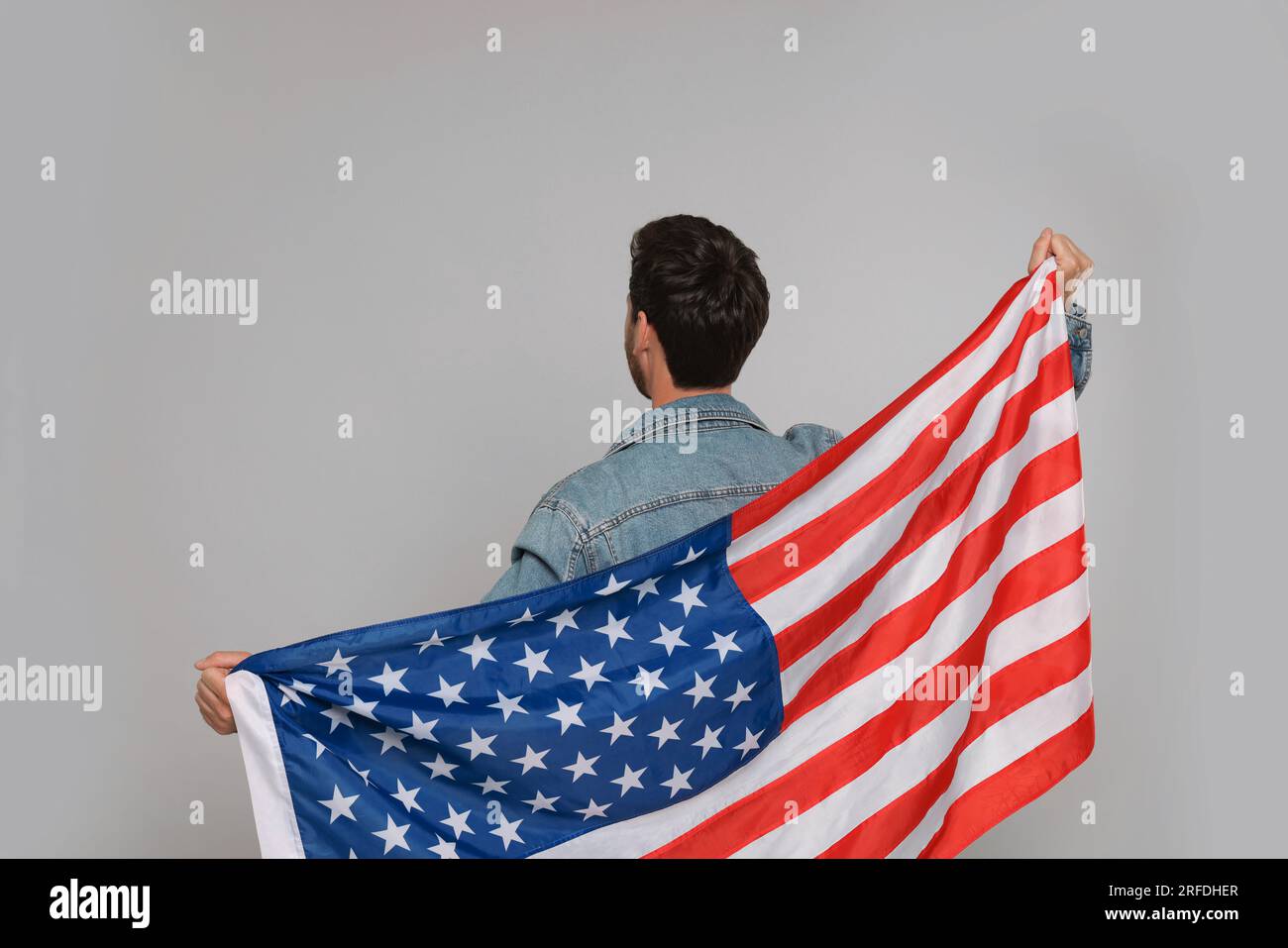 Back view of man with american flag hi-res stock photography and images ...