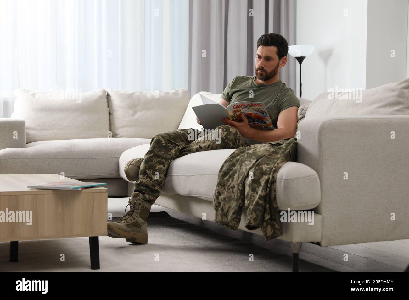 Soldier in military uniform magazine hi-res stock photography and ...