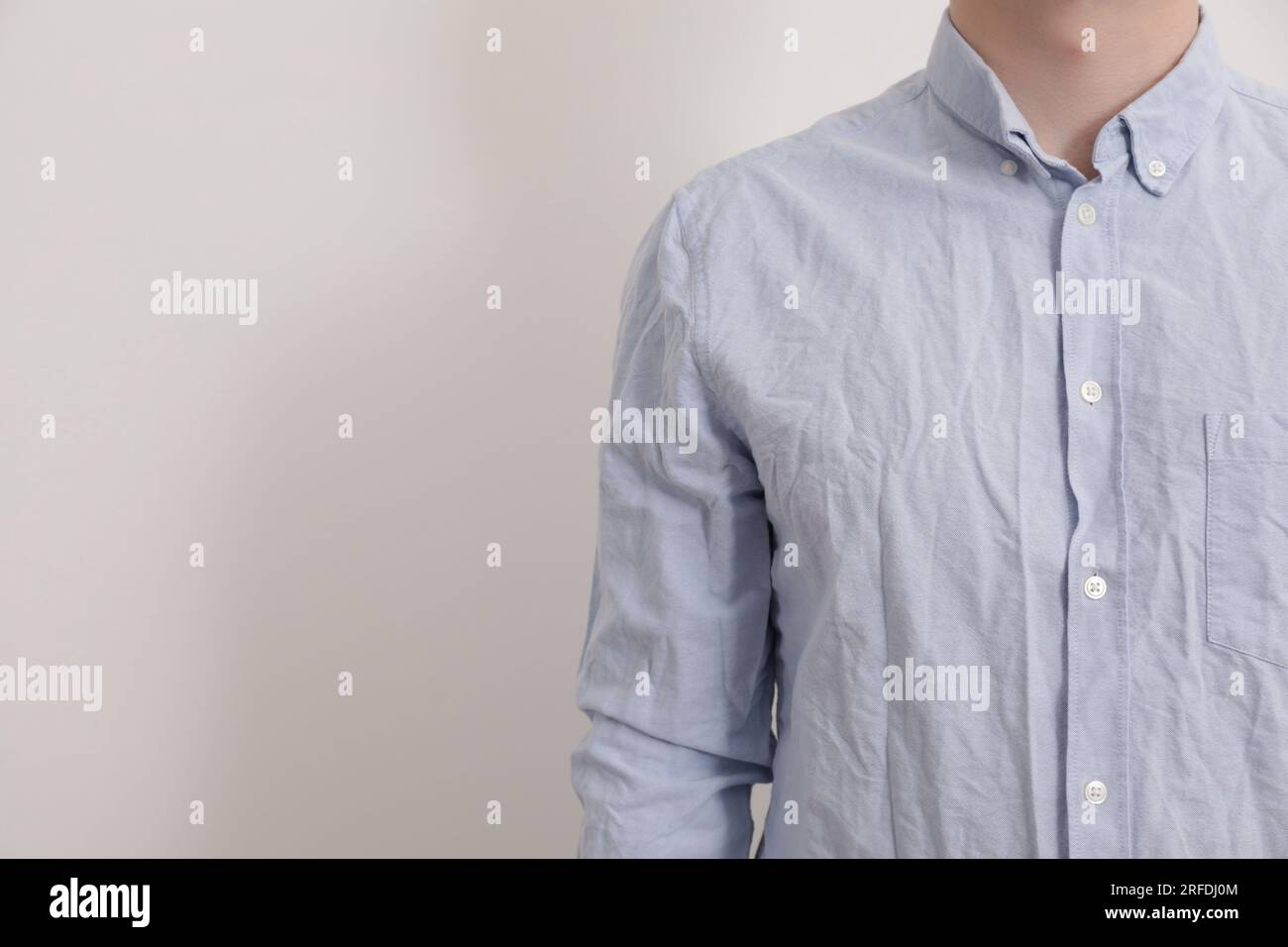 Man wearing rumpled shirt on white background, closeup Stock Photo - Alamy