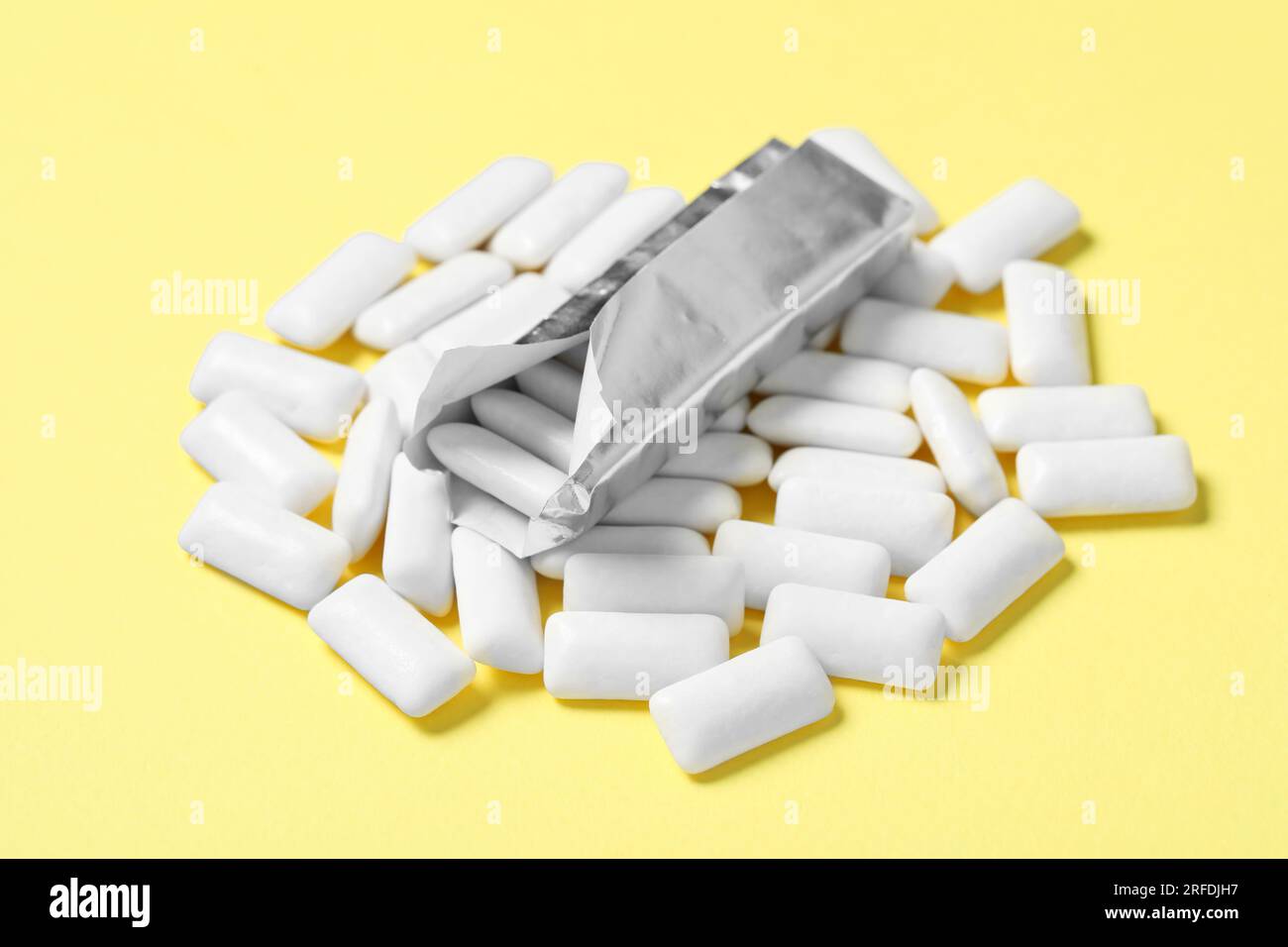 Pack with tasty chewing gums on yellow background Stock Photo - Alamy
