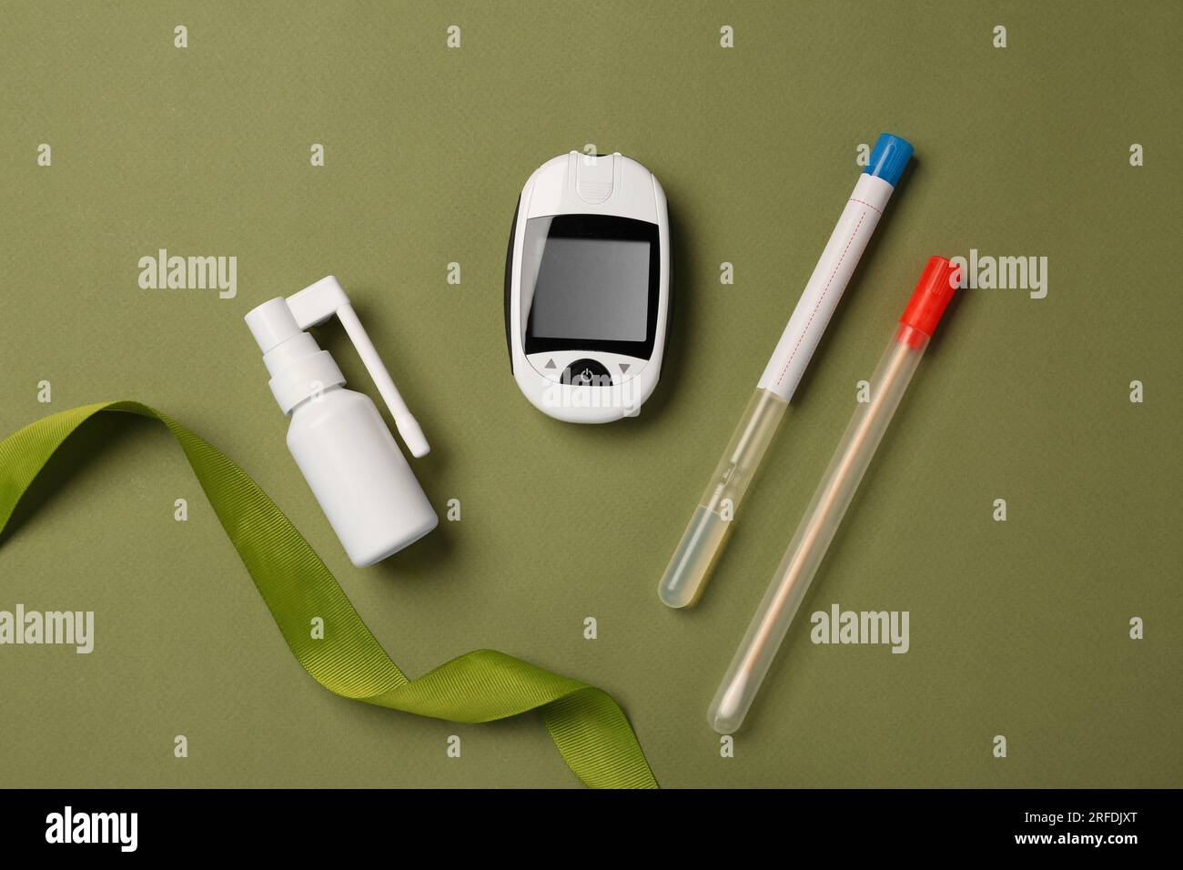 Spray bottle, sample collection kit and digital glucometer on olive ...