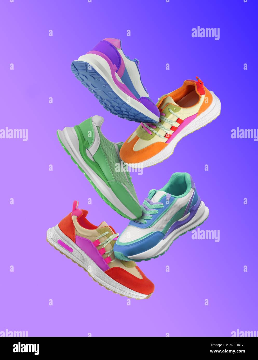 Different sneakers falling on blue gradient background Stock Photo - Alamy