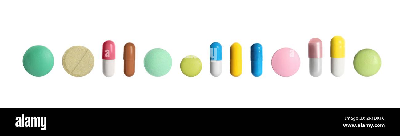 Set of different color pills in row isolated on white Stock Photo - Alamy