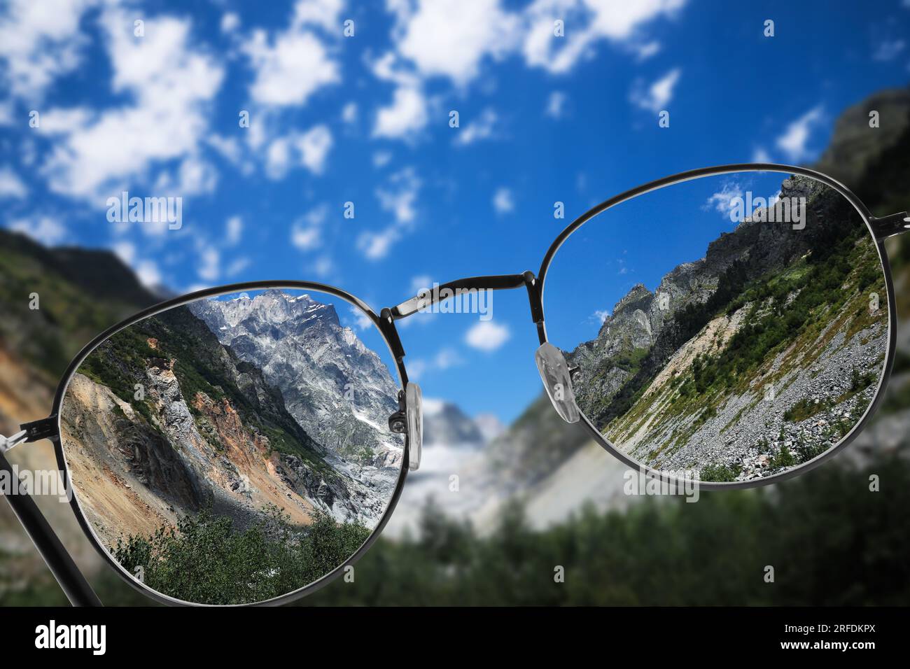 Vision correction. Mountain landscape becoming clearer when looking ...