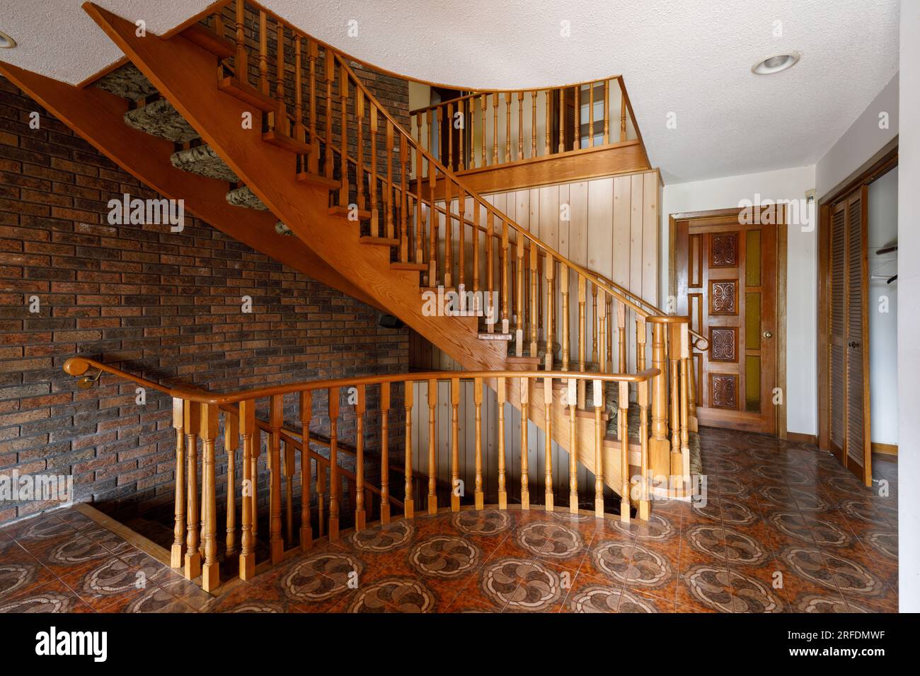 A semicircular staircase inisde a large home Stock Photo - Alamy