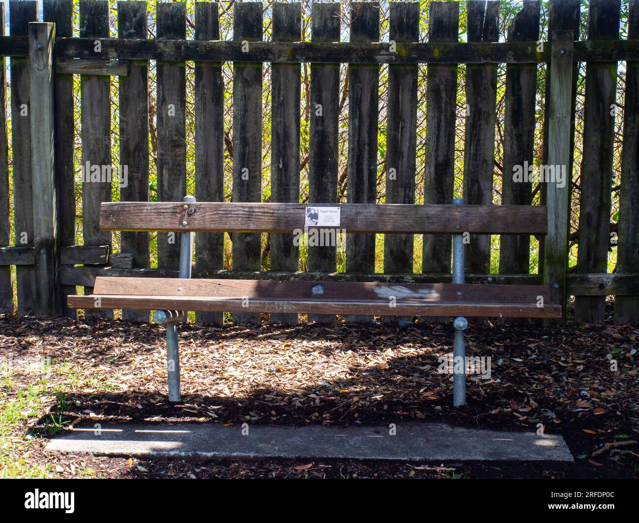Park Bench Seat By Wooden Fence Stock Photo - Alamy