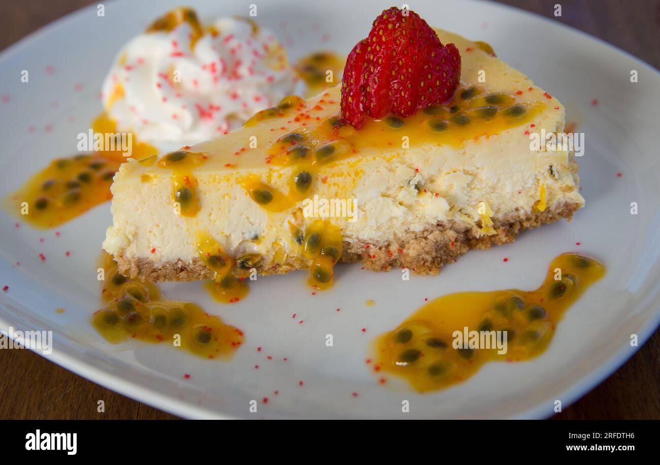 Slice of Passion Fruit Cheesecake topped with a strawberry Stock Photo ...