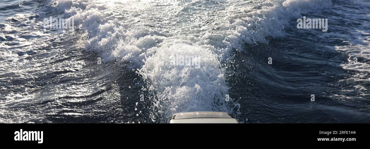Boat engine and water trail with waves and foam behind it Stock Photo ...