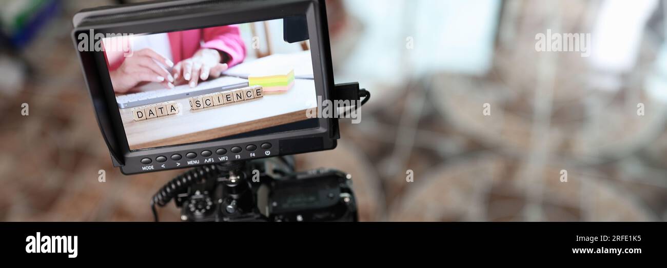 Digital camera with external monitor on camera slider filming woman ...