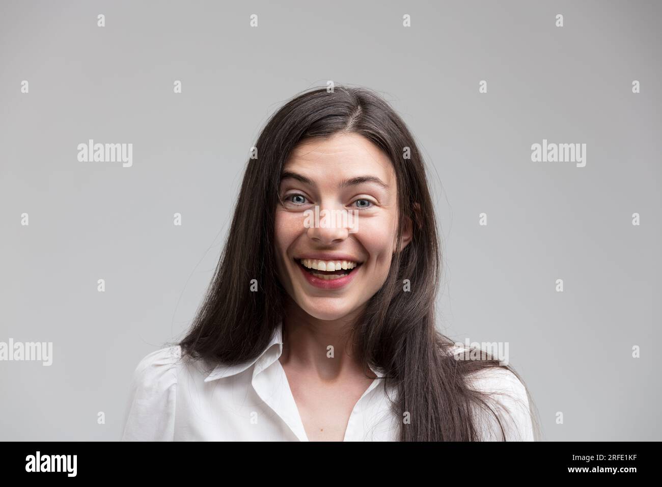 Central frontal shot of a woman, positively impacted, laughing with ...