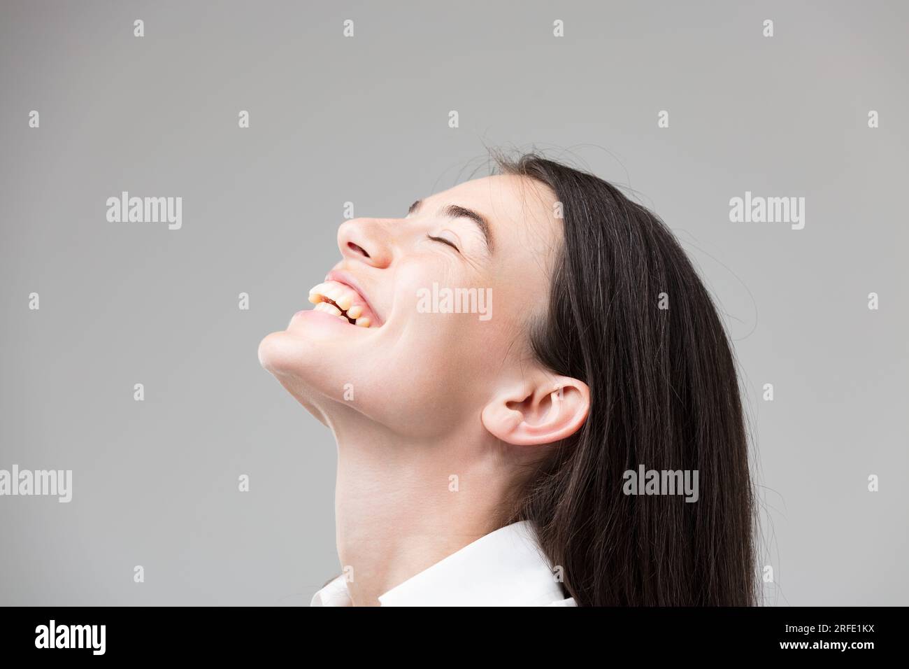 Woman with intense, uncontrollable joy, smiling and laughing. Central ...
