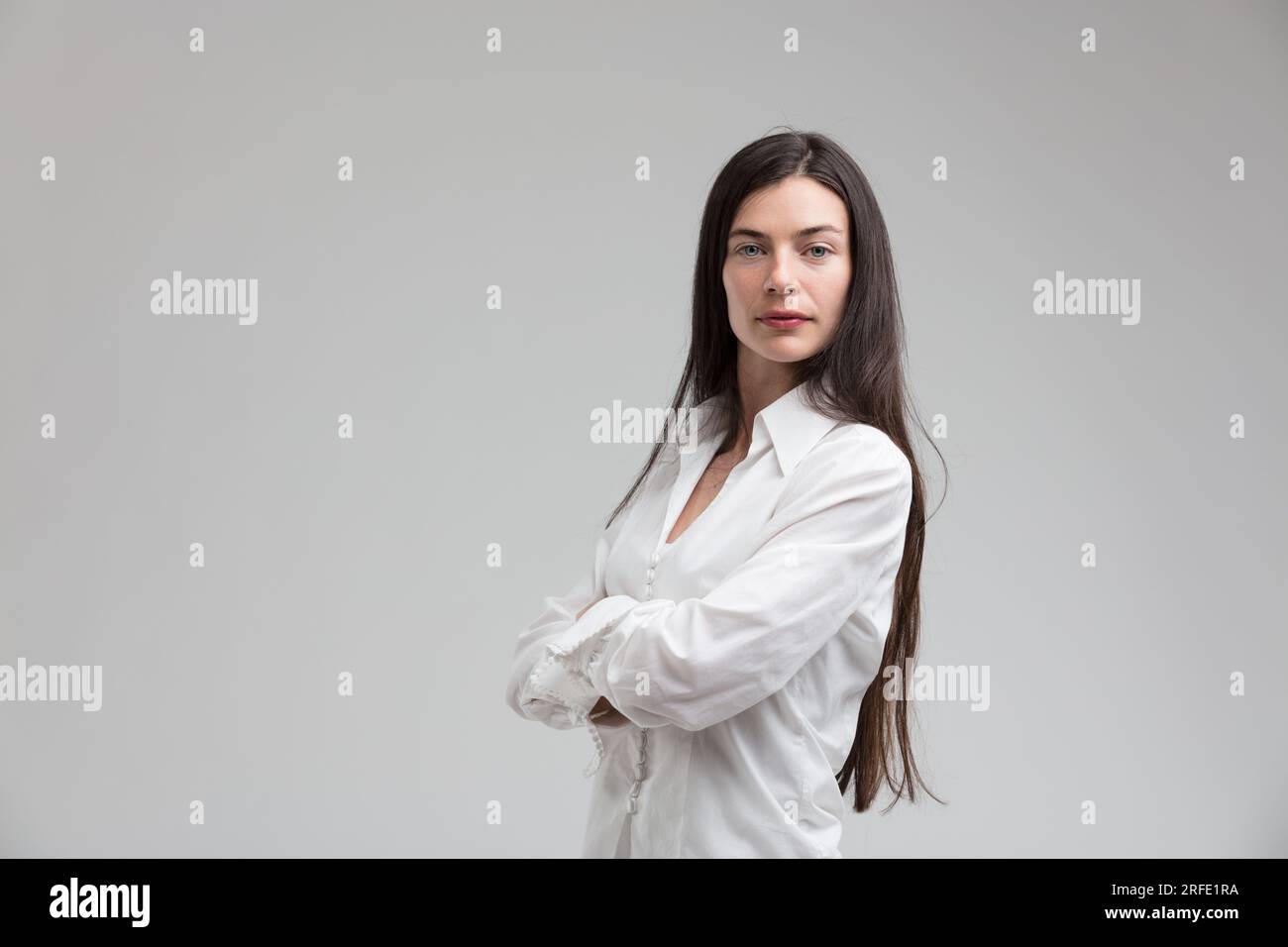 determined, beautiful woman in white asserts her perfection. Her ...