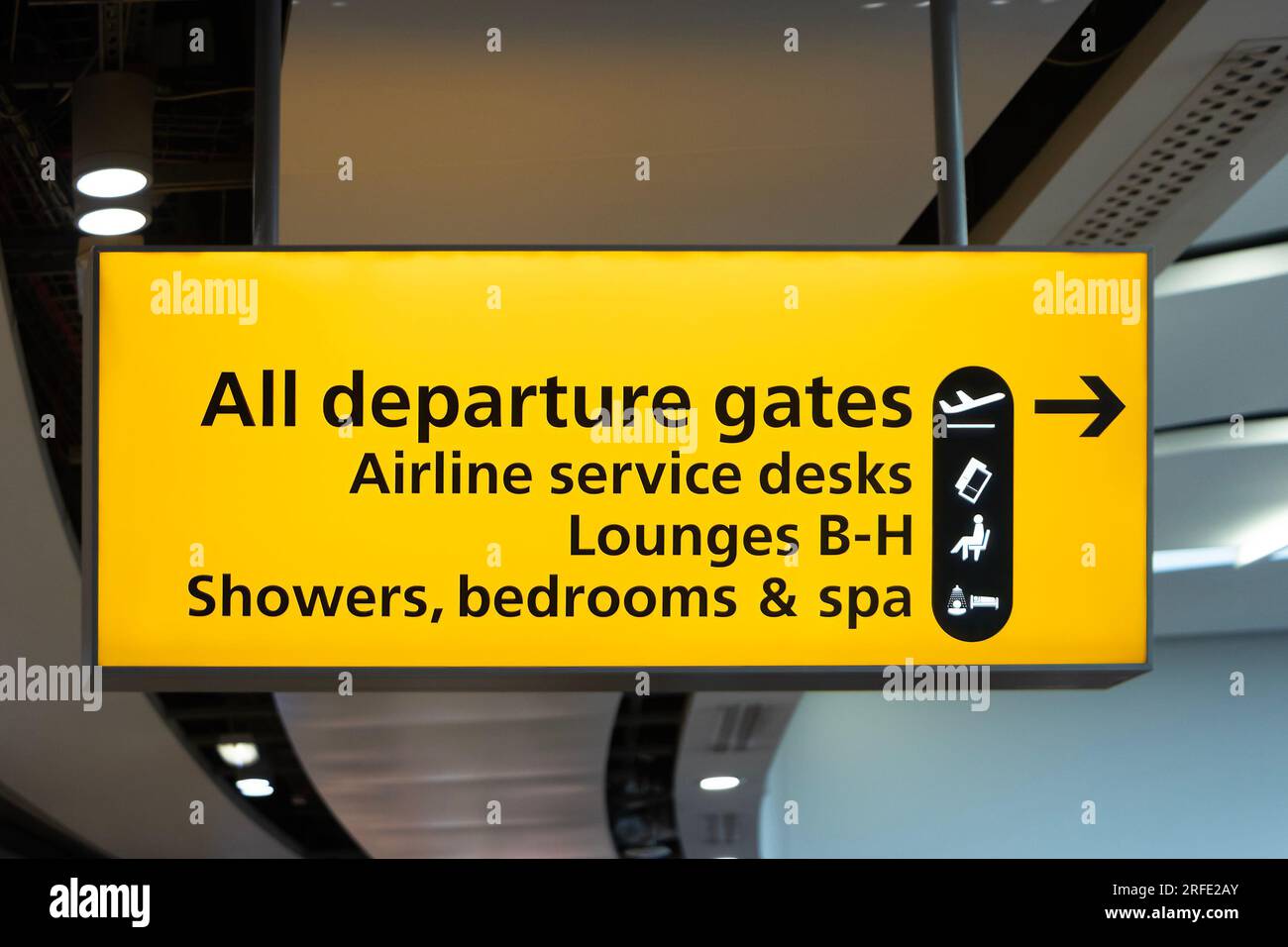 Yellow departure gates direction sign hanging in Heathrow Airport ...