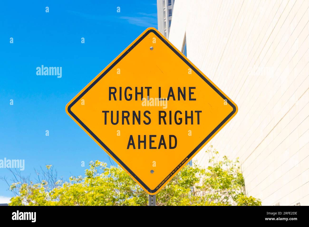yellow diamond traffic sign right lane must turn right ahead in street ...