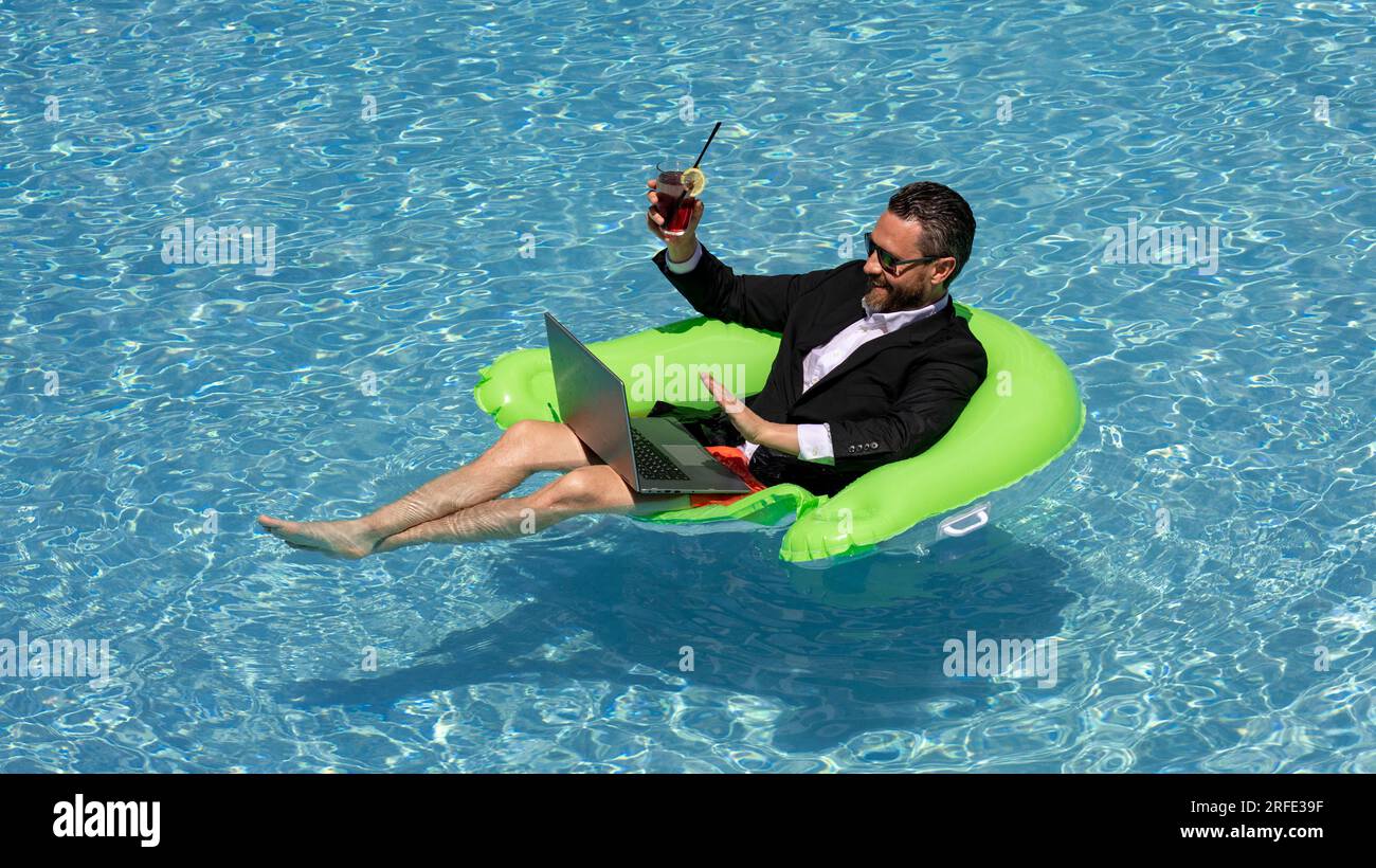 Handsome man floating in pool hi-res stock photography and images - Alamy