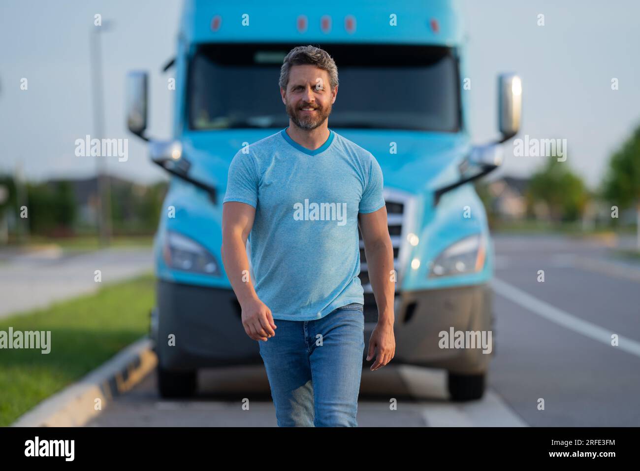 Men driver near lorry truck. Man owner truck driver near truck. Handsome middle aged man trucker ...