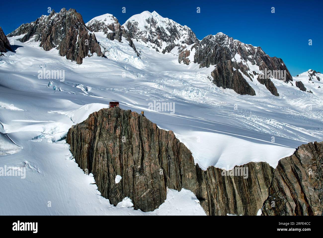 Flying over the tallest snow covered peaks of the Southern alps in a ...