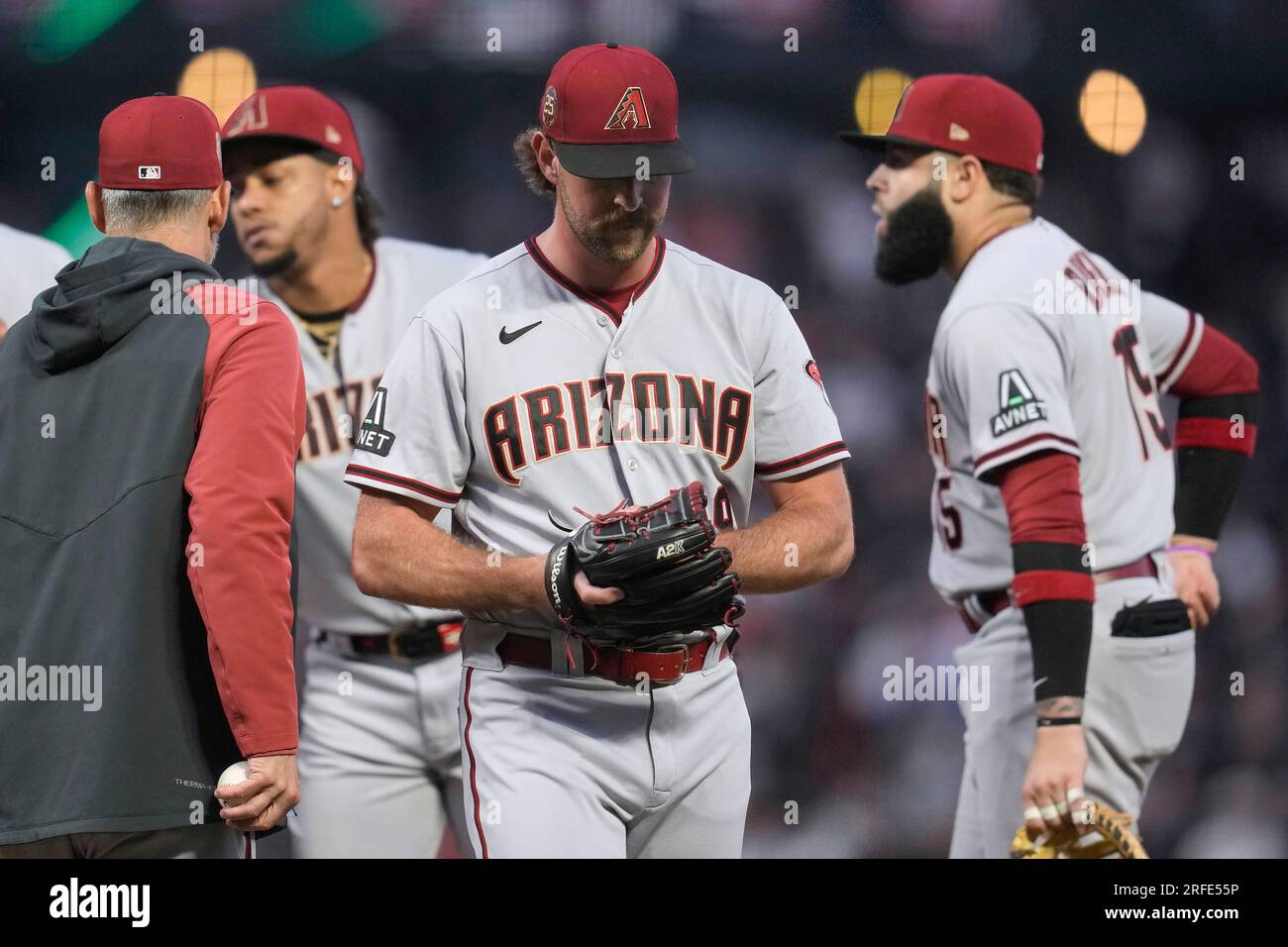Arizona Diamondbacks pitcher Tyler Gilbert, middle, walks to the dugout ...