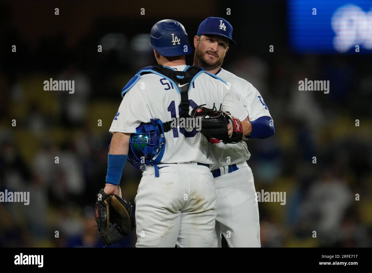 Los Angeles Dodgers relief pitcher Ryan Brasier, right, hugs catcher ...