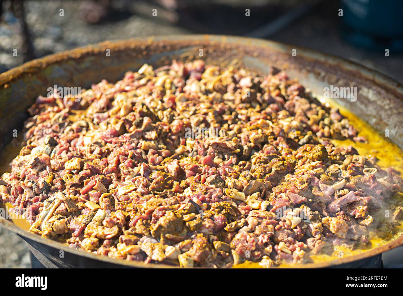 Cooking using a charcoal stove and a large pan Stock Photo - Alamy