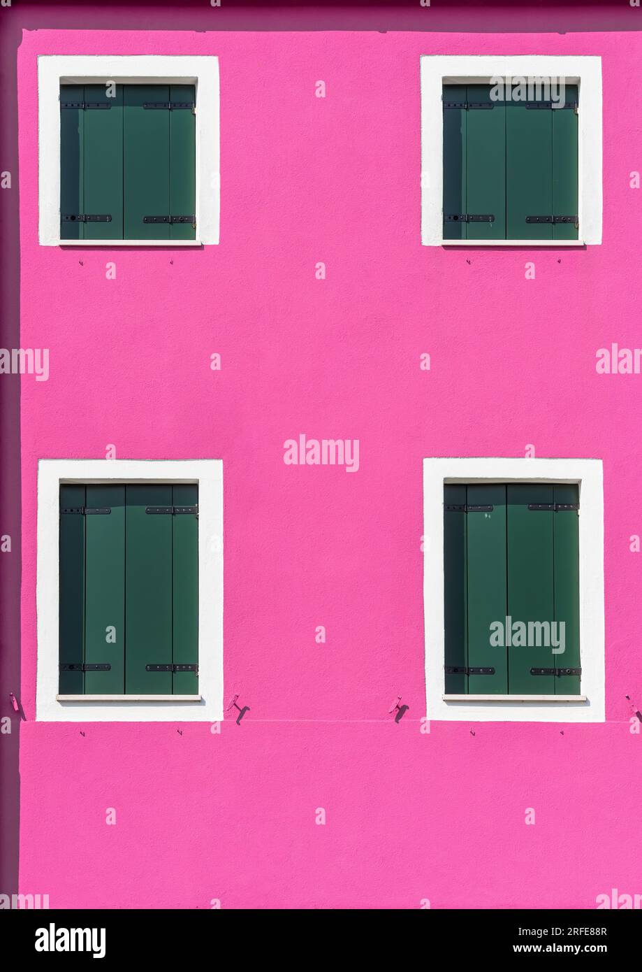 Detail with a pink colorful house window with green painted wooden ...