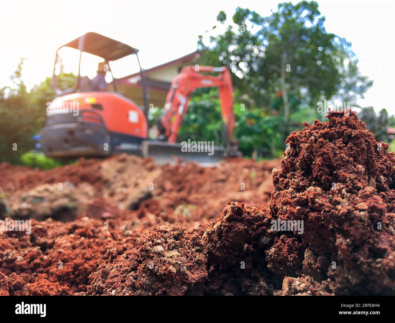 Soil close up blurred backhoe to renovate the site in preparation for ...