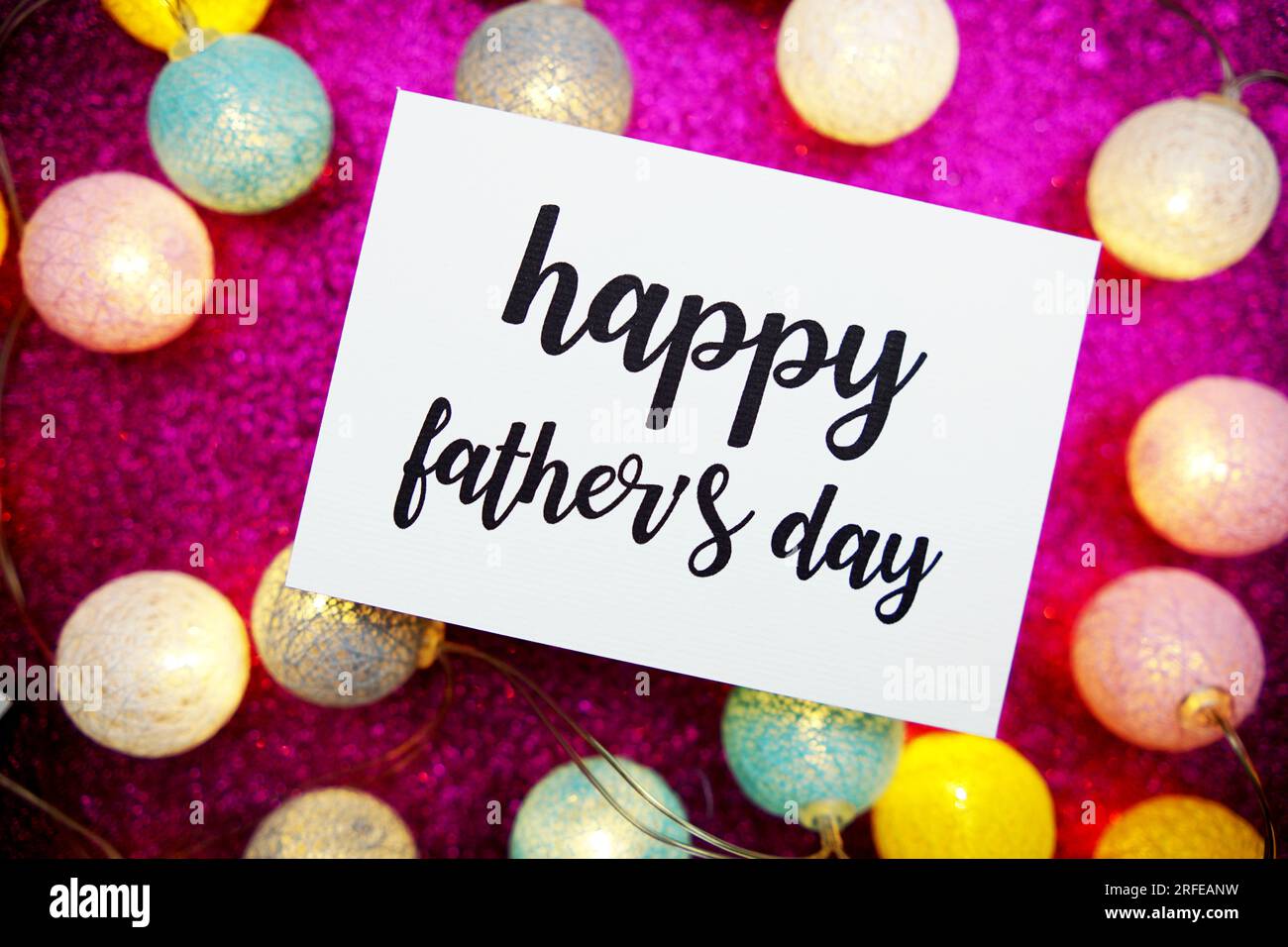 Happy Father's Day text on paper card with LED cotton balls decorate on ...