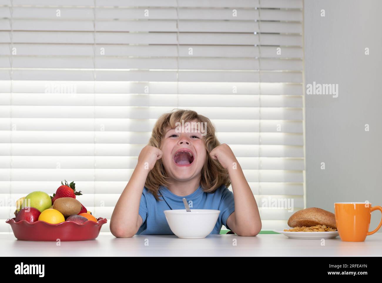 Excited child eats organic food. Healthy vegetables with vitamins ...