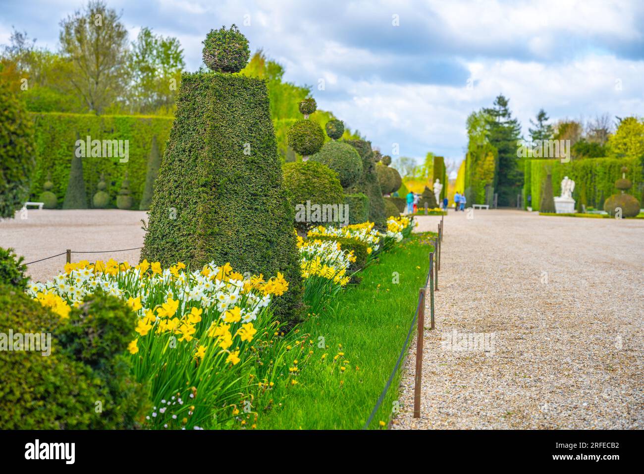 Trimmed trees and flower beds in the Gardens of Versailles, Chateau ...