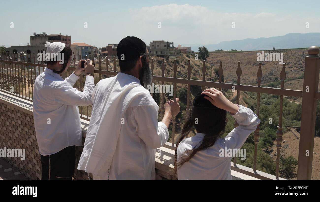 Israeli orthodox Jews stand at an observation point in the Israeli ...